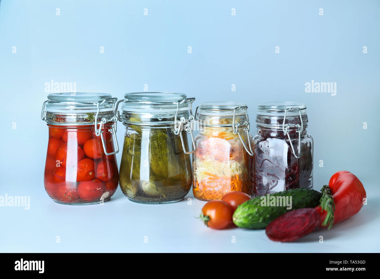 Glass jars with fermented vegetables on white background Stock Photo ...