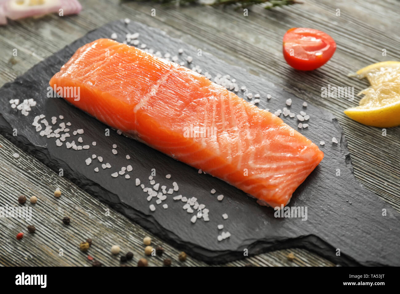 Raw salmon fillet on slate board Stock Photo - Alamy