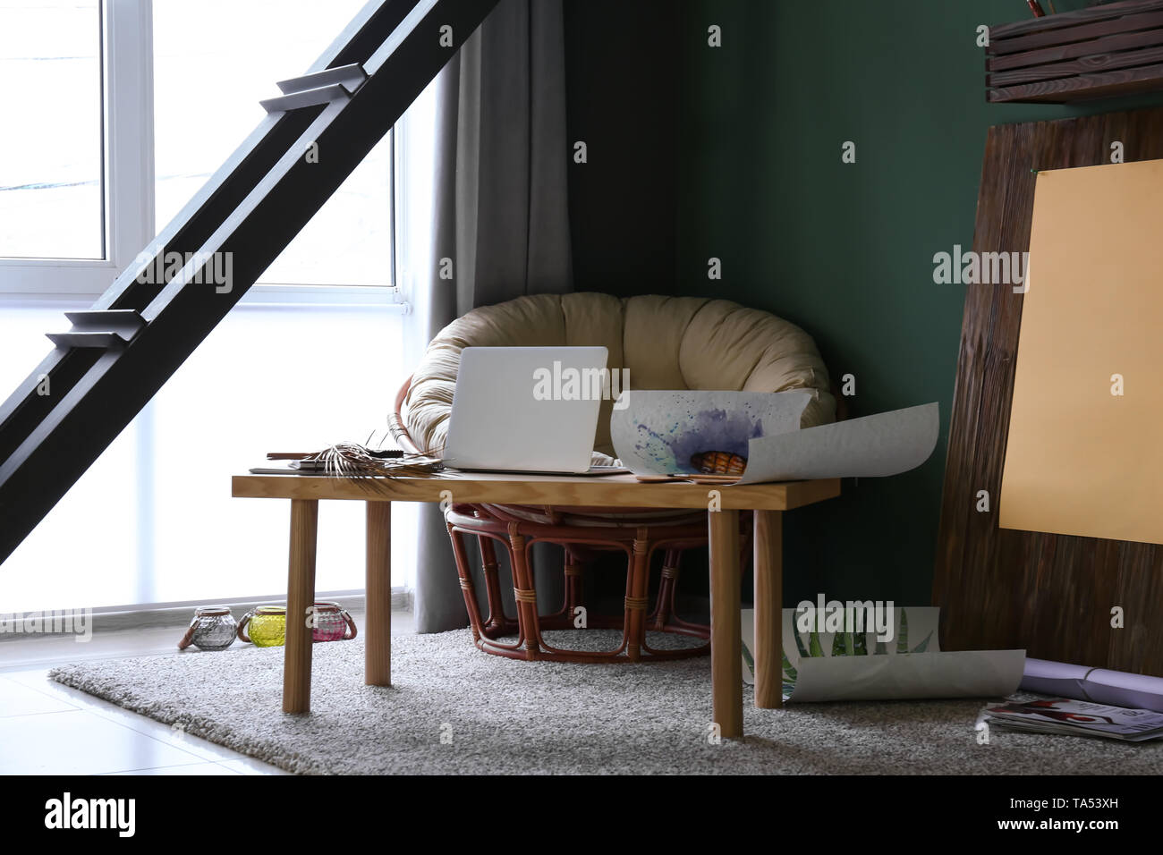 Interior of modern room with artist's workplace Stock Photo - Alamy