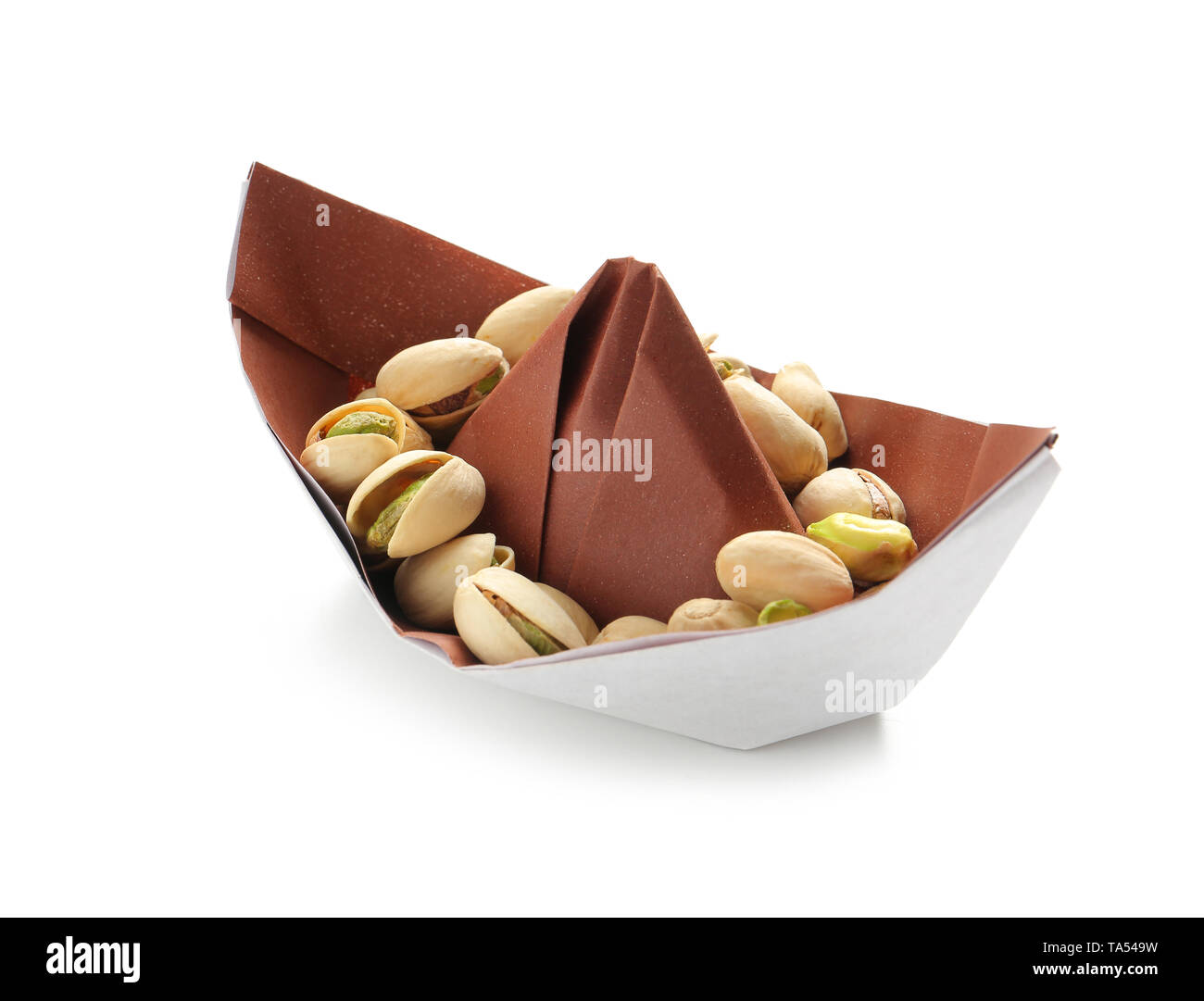 Paper boat with tasty pistachio nuts on white background Stock Photo ...