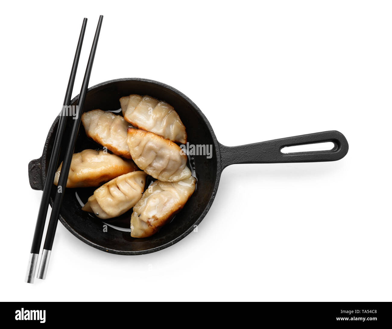 Frying pan with tasty Japanese gyoza on white background Stock Photo ...