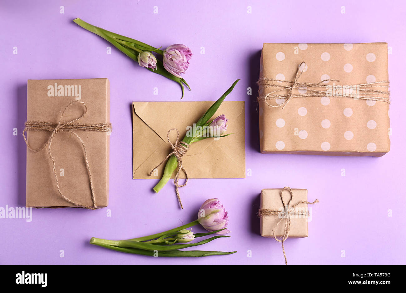 Composition with beautiful gift boxes and flowers on color background ...