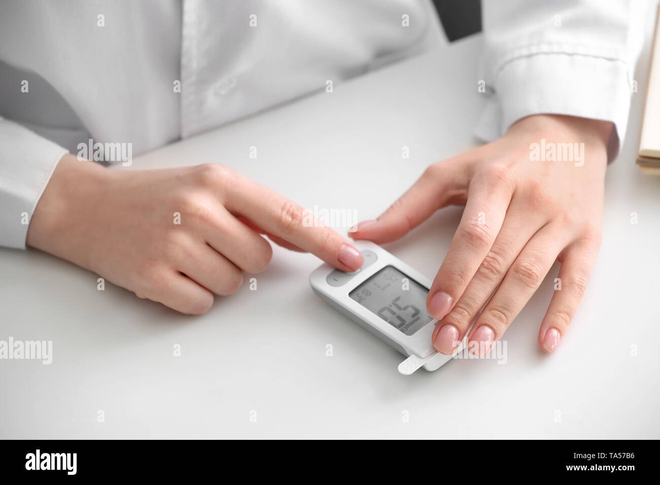 Woman taking diabetes test glucometer hi-res stock photography and ...