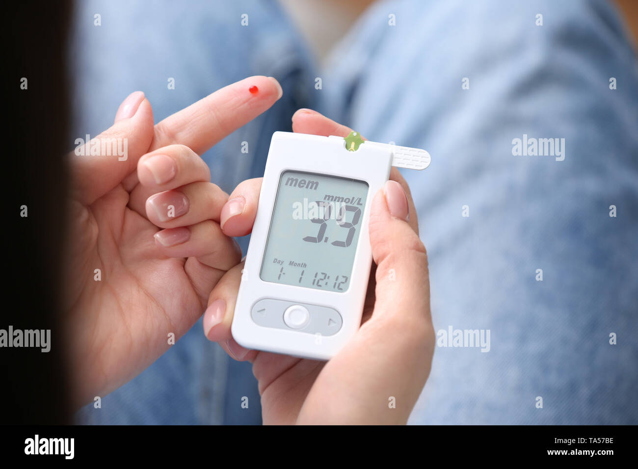 Woman taking diabetes test glucometer hi-res stock photography and ...