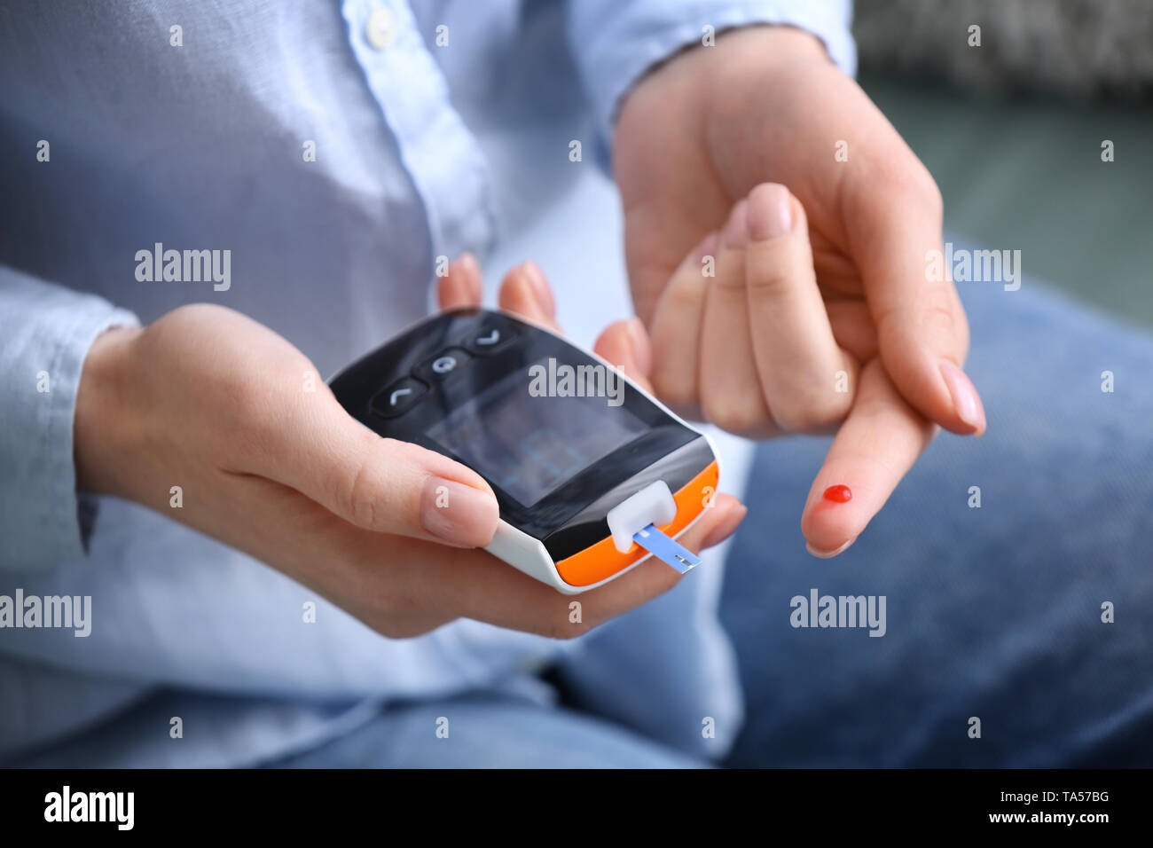 Woman taking diabetes test glucometer hi-res stock photography and ...
