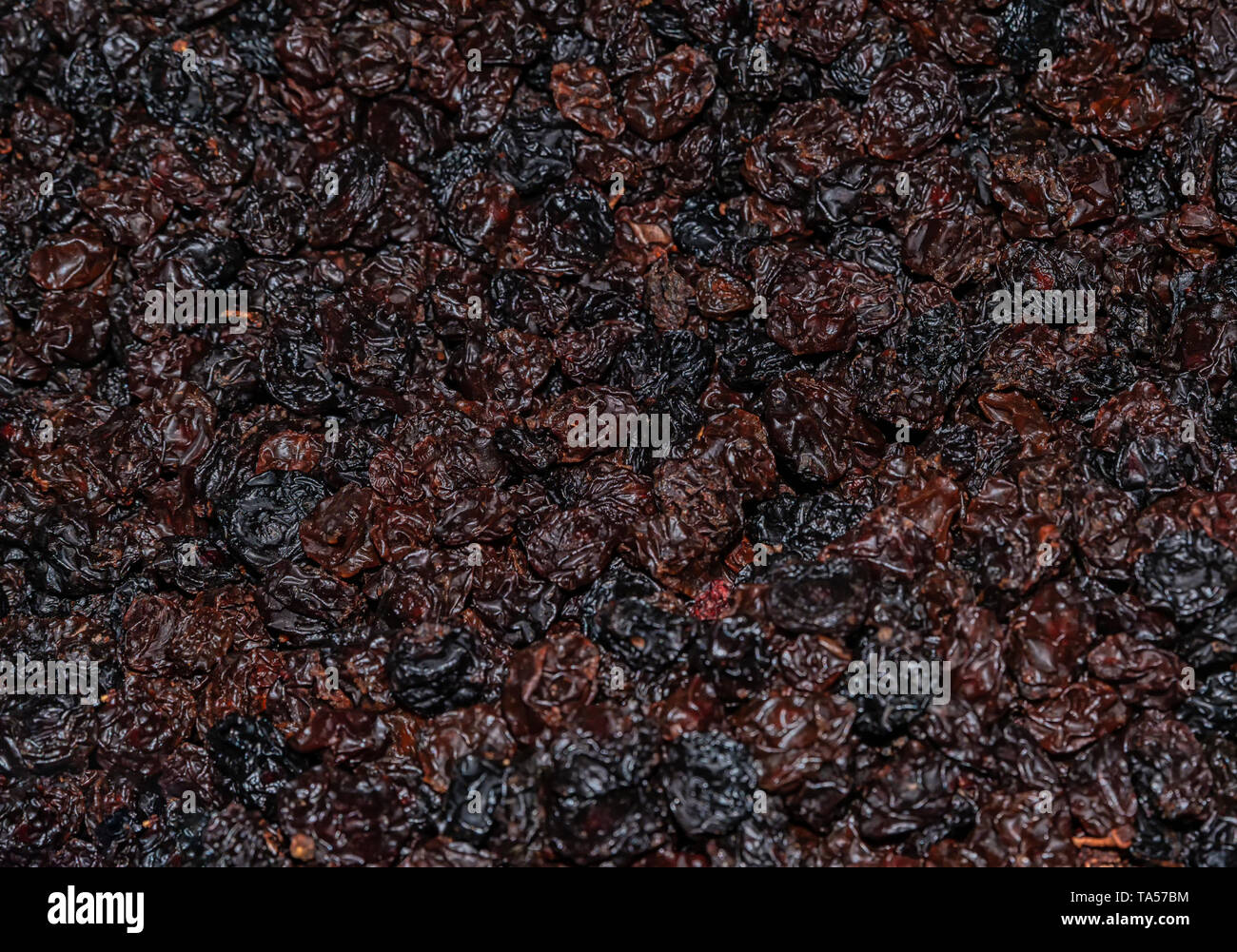 Close up of black raisins isolated Stock Photo - Alamy