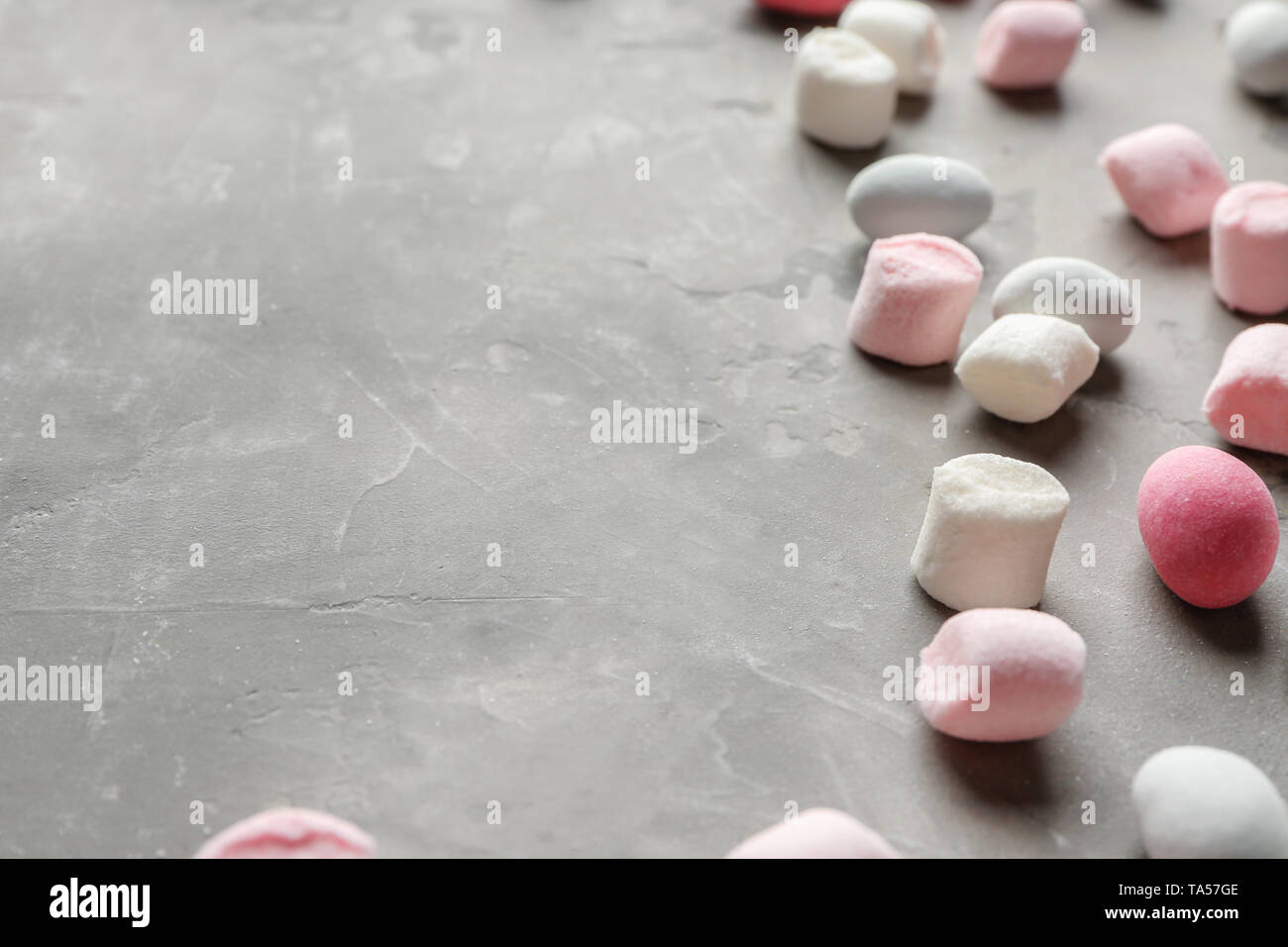 Different sweets on grey background Stock Photo - Alamy