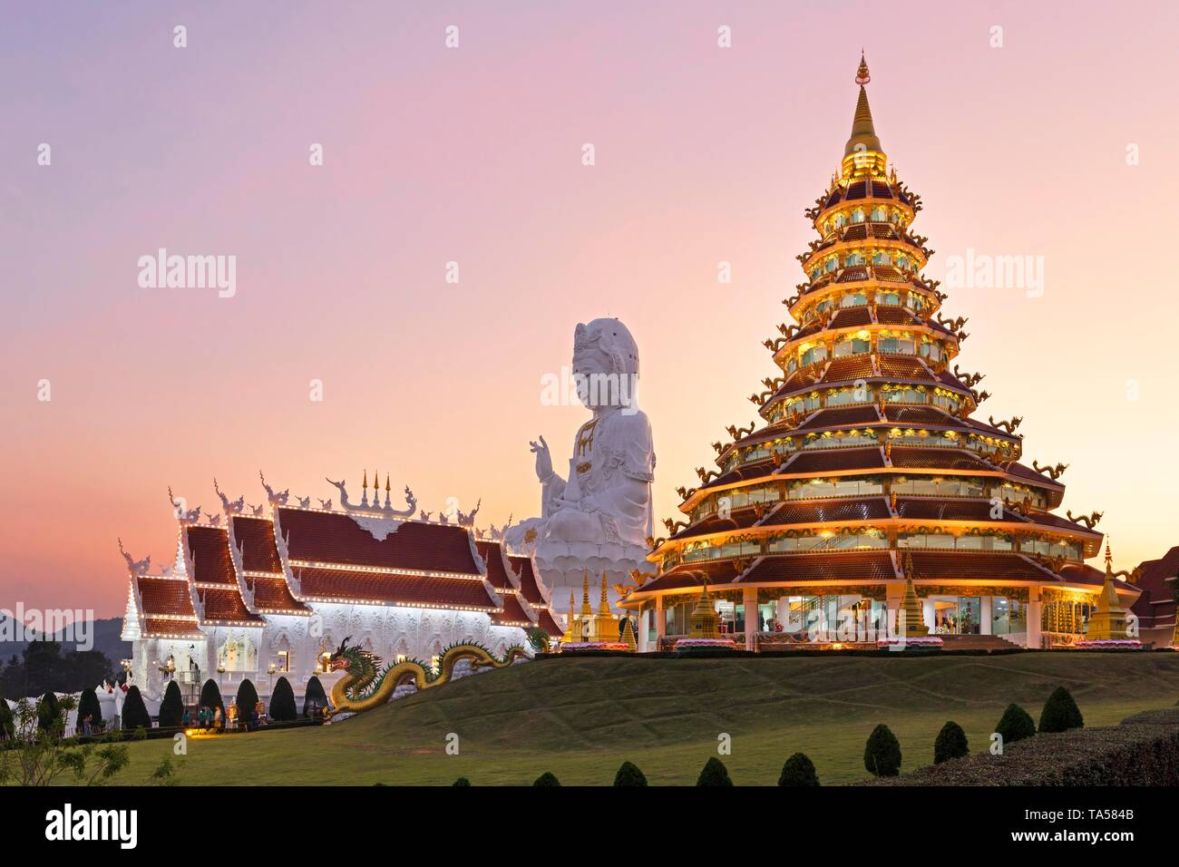 Nine-storey Chinese pagoda and chapel in front of huge Guan Yin statue ...