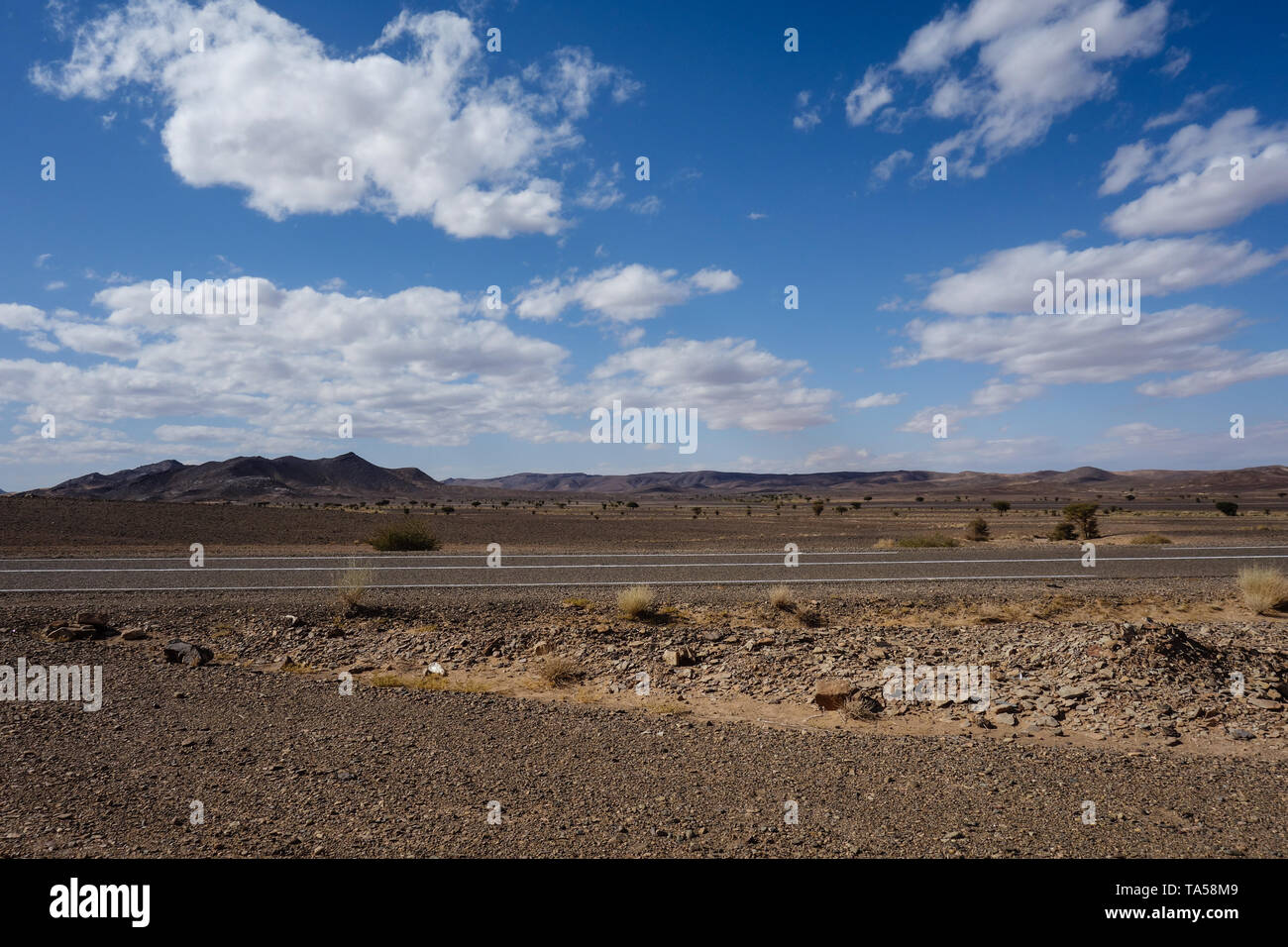 Moroccan highway featuring a rocky desert landscape on a road-trip from ...