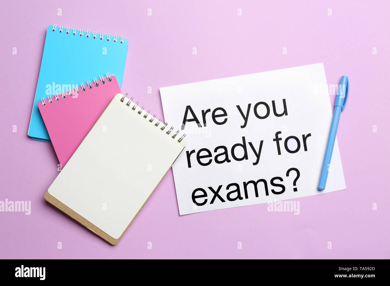 Notebooks and paper with text ARE YOU READY FOR EXAMS? on color ...