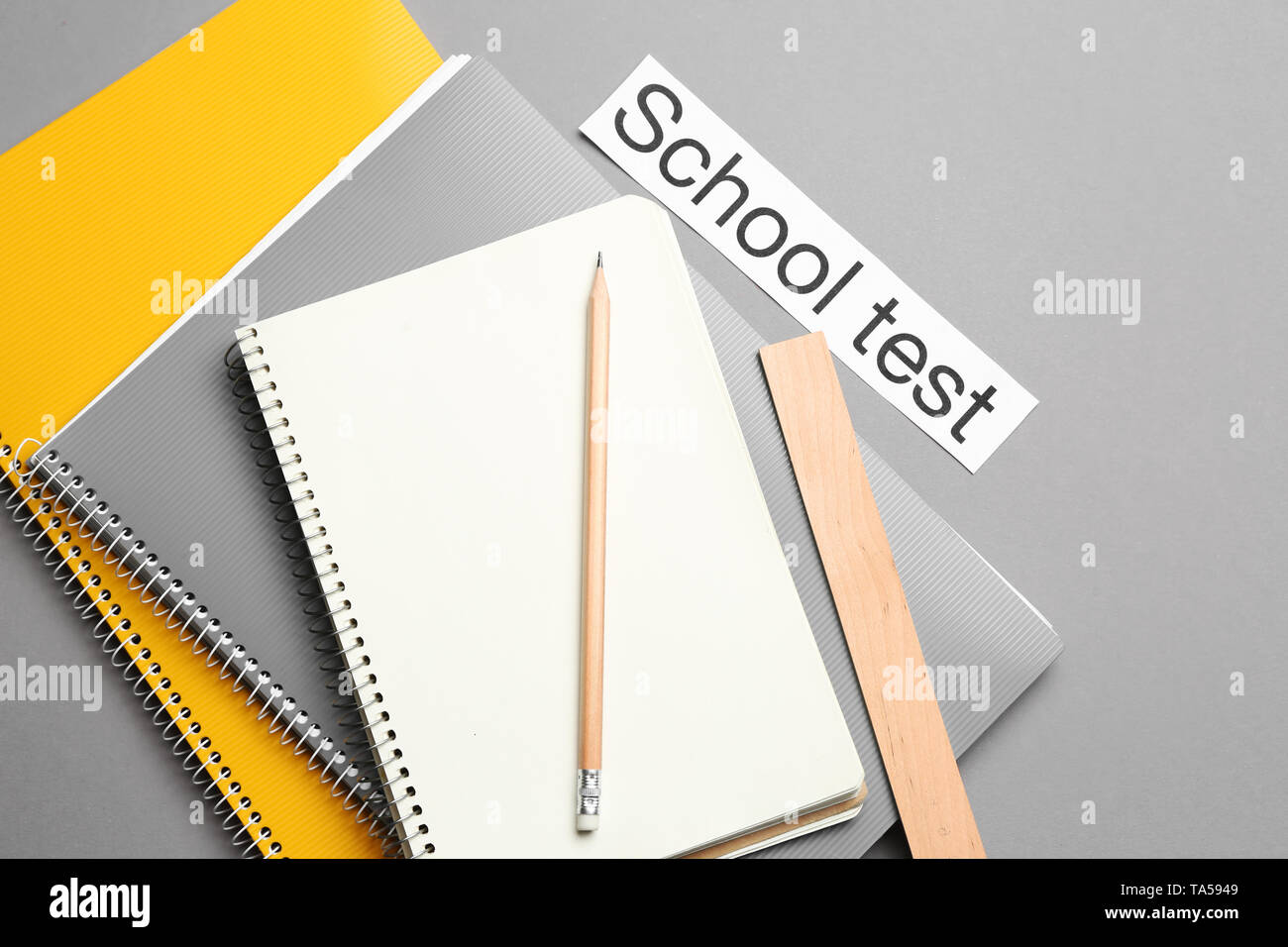 Stationery and paper with text SCHOOL TEST on grey background Stock ...