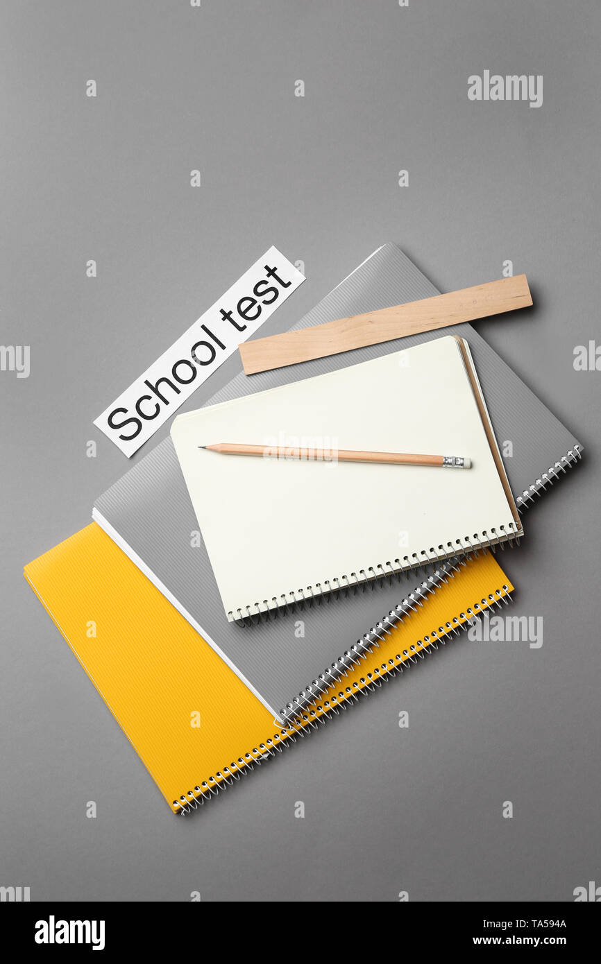 Stationery and paper with text SCHOOL TEST on grey background Stock ...