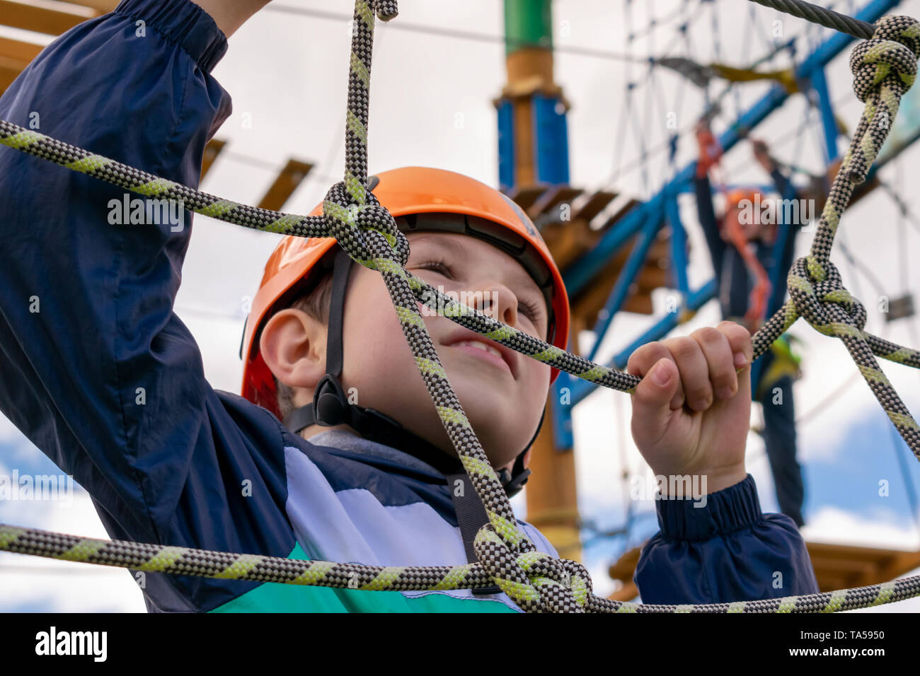 Little boy climbing a rope hi-res stock photography and images - Alamy