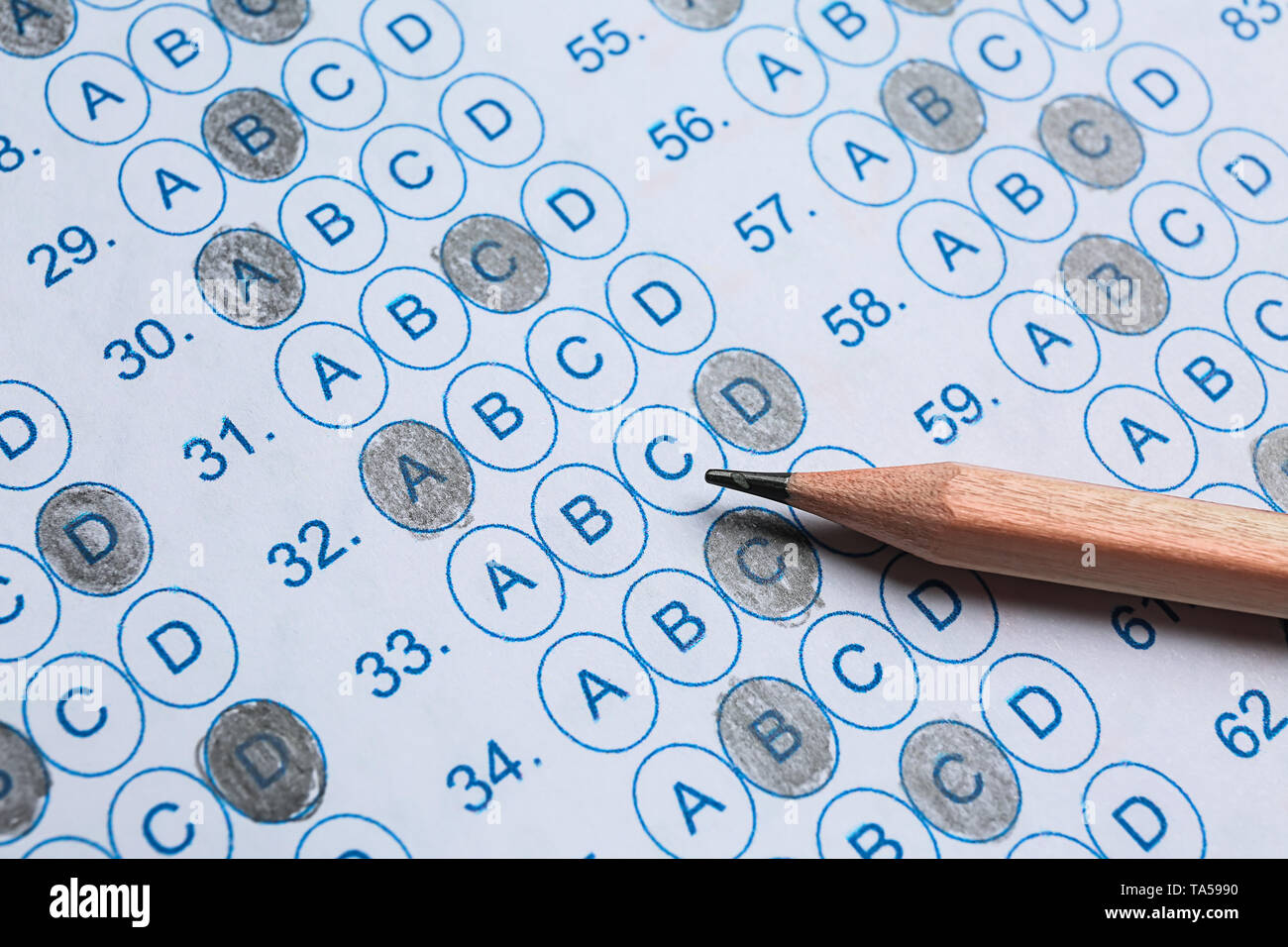 Pencil on filled answer sheet form, closeup. Concept of passing exam ...