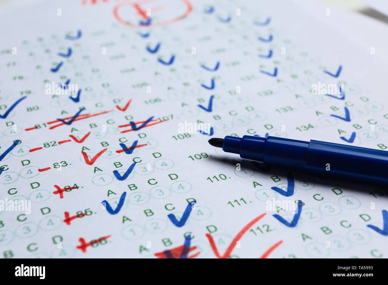 Felt-tip pen on checked answer sheet, closeup. Concept of passing exam ...