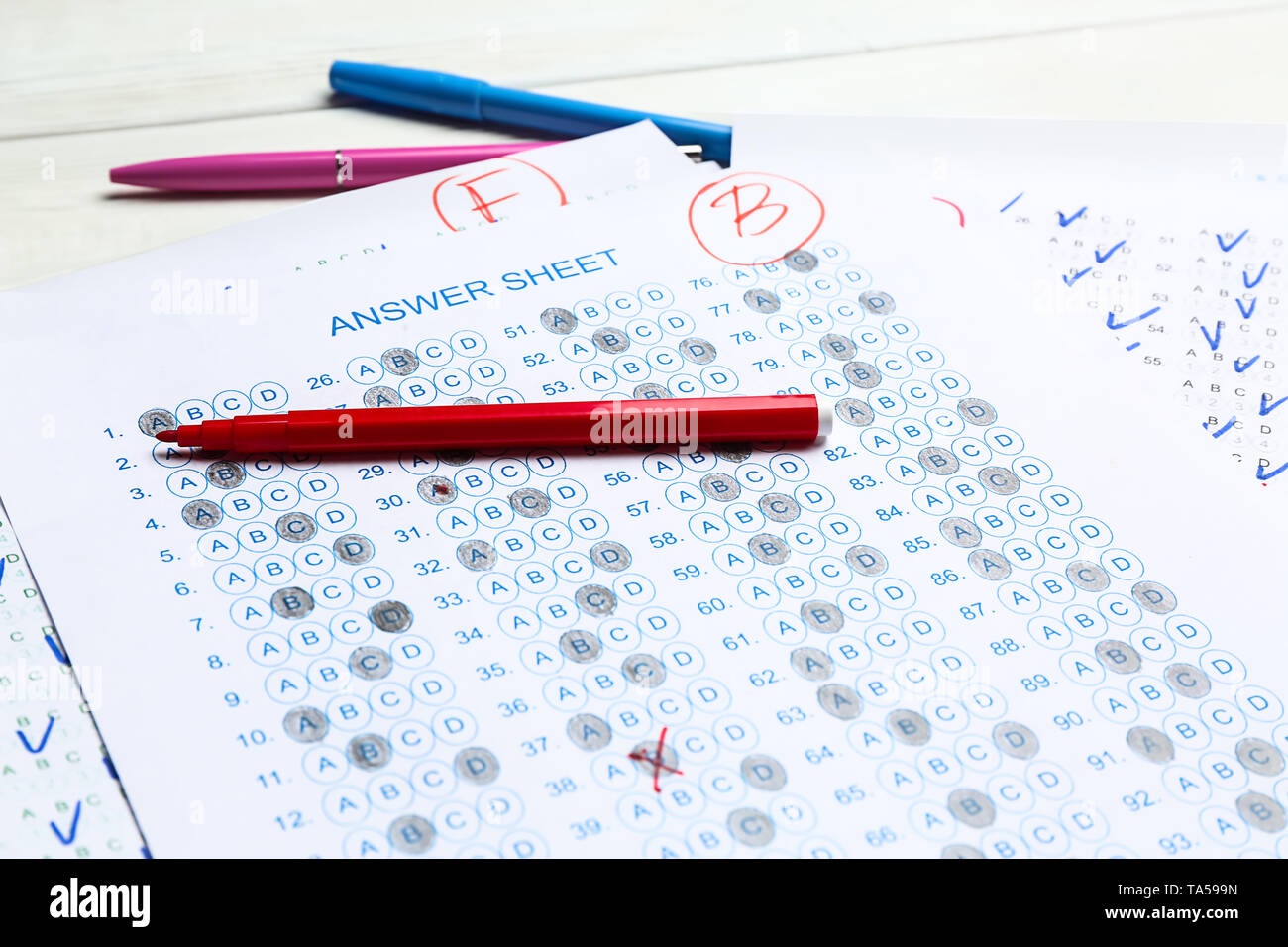 Checked answer sheets on table. Concept of passing exam Stock Photo - Alamy