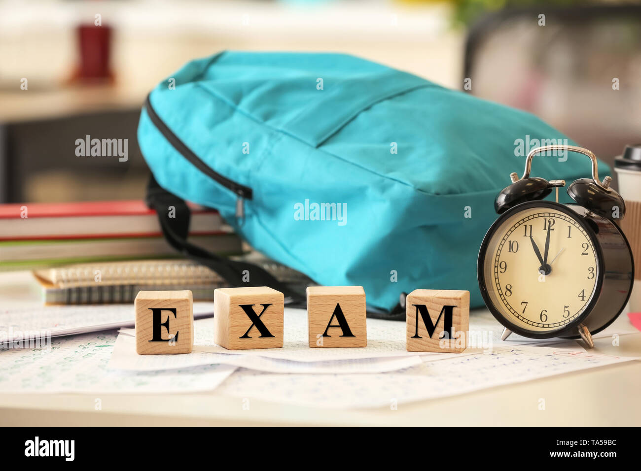 Wooden cubes, stationery and clock on table. Concept of preparation for ...