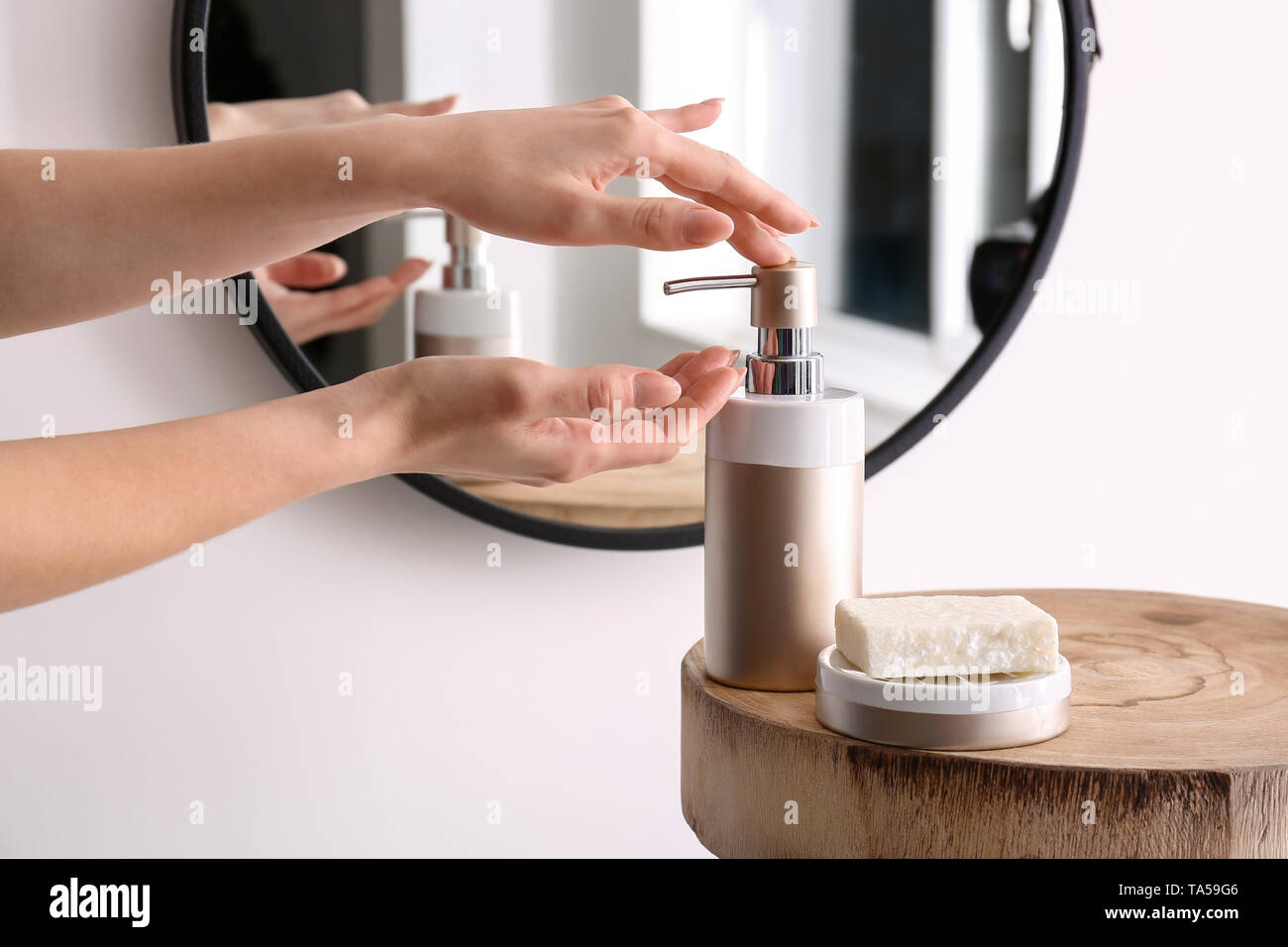 Woman washing hands with liquid soap in bathroom Stock Photo - Alamy