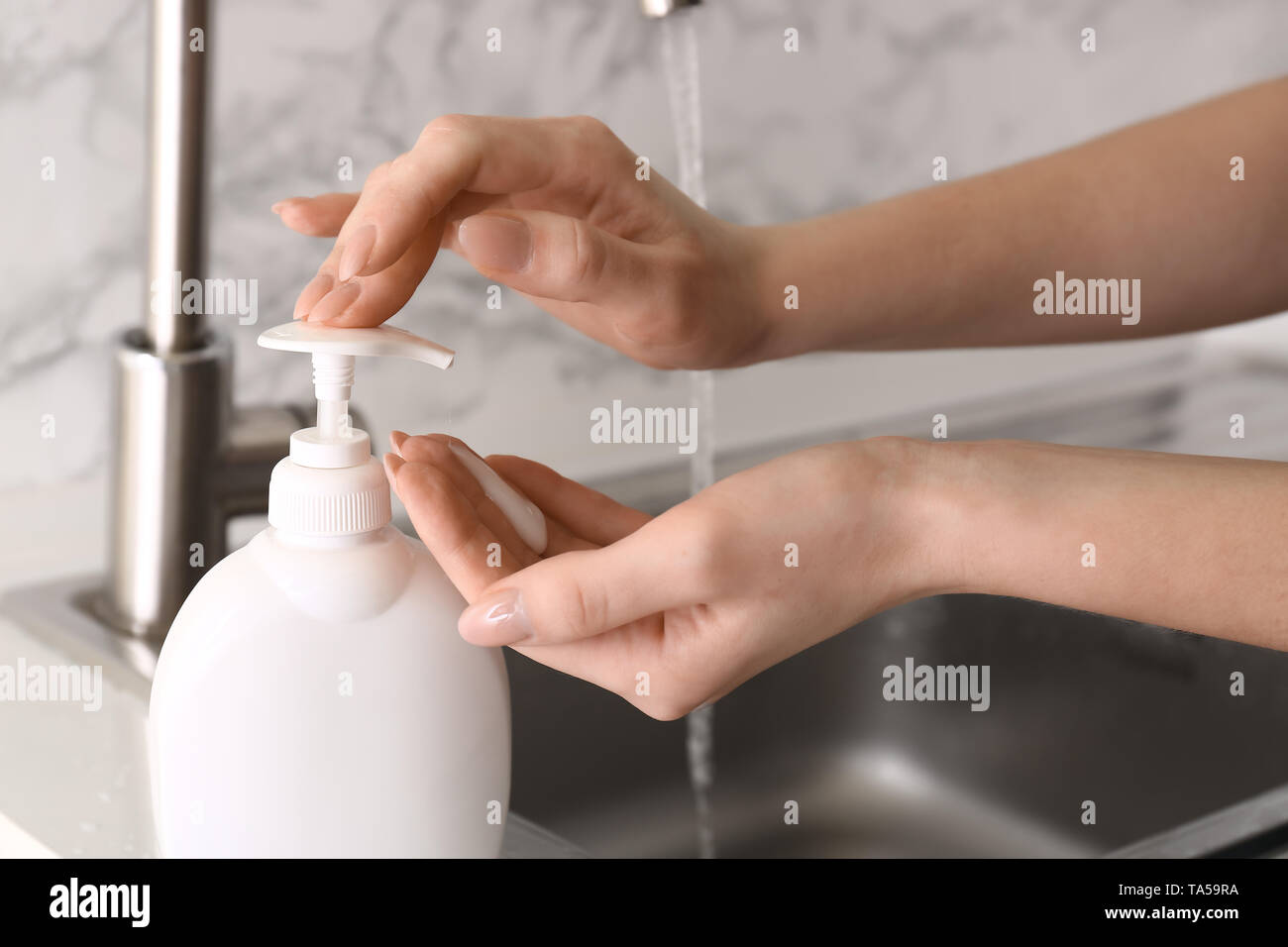 Woman washing hands with liquid soap Stock Photo - Alamy