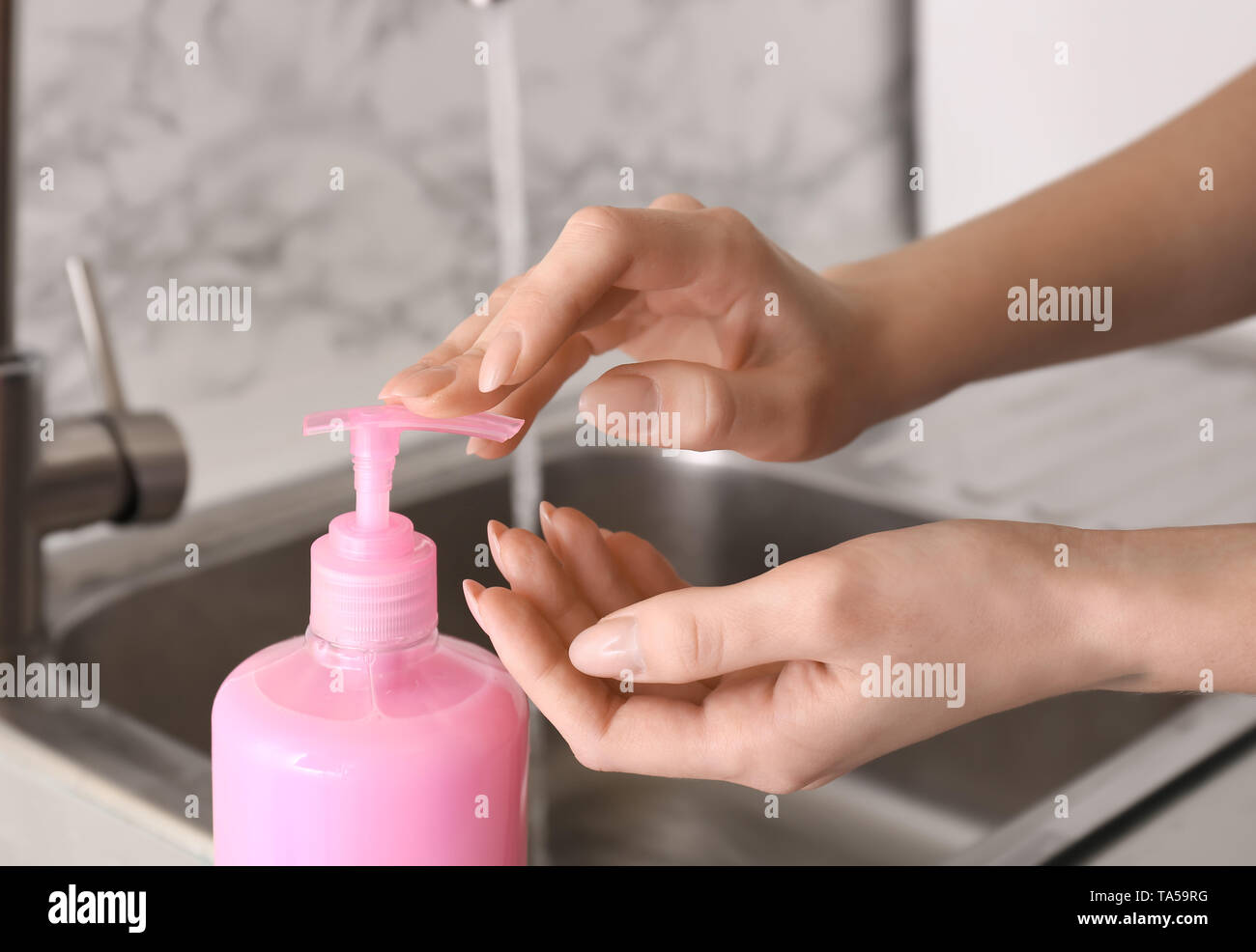 Woman washing hands with liquid soap Stock Photo - Alamy