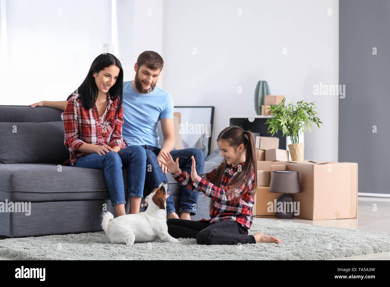Happy family after moving into new house Stock Photo - Alamy