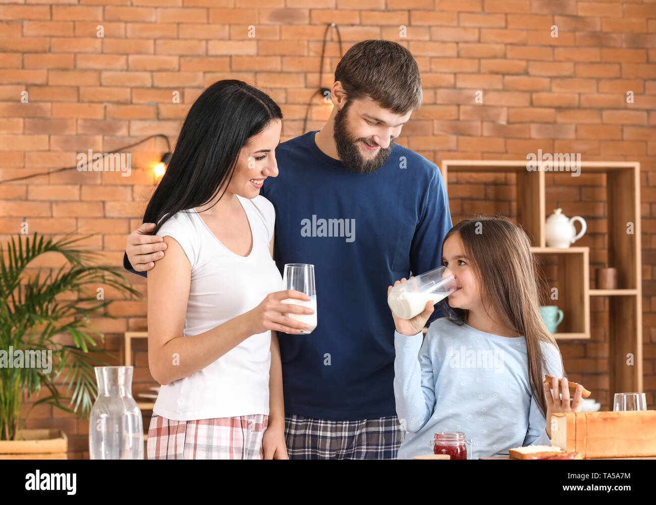 Happy family having breakfast at home Stock Photo - Alamy