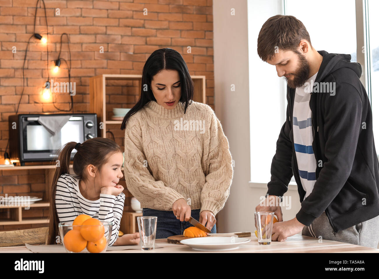 Happy family having breakfast at home Stock Photo - Alamy