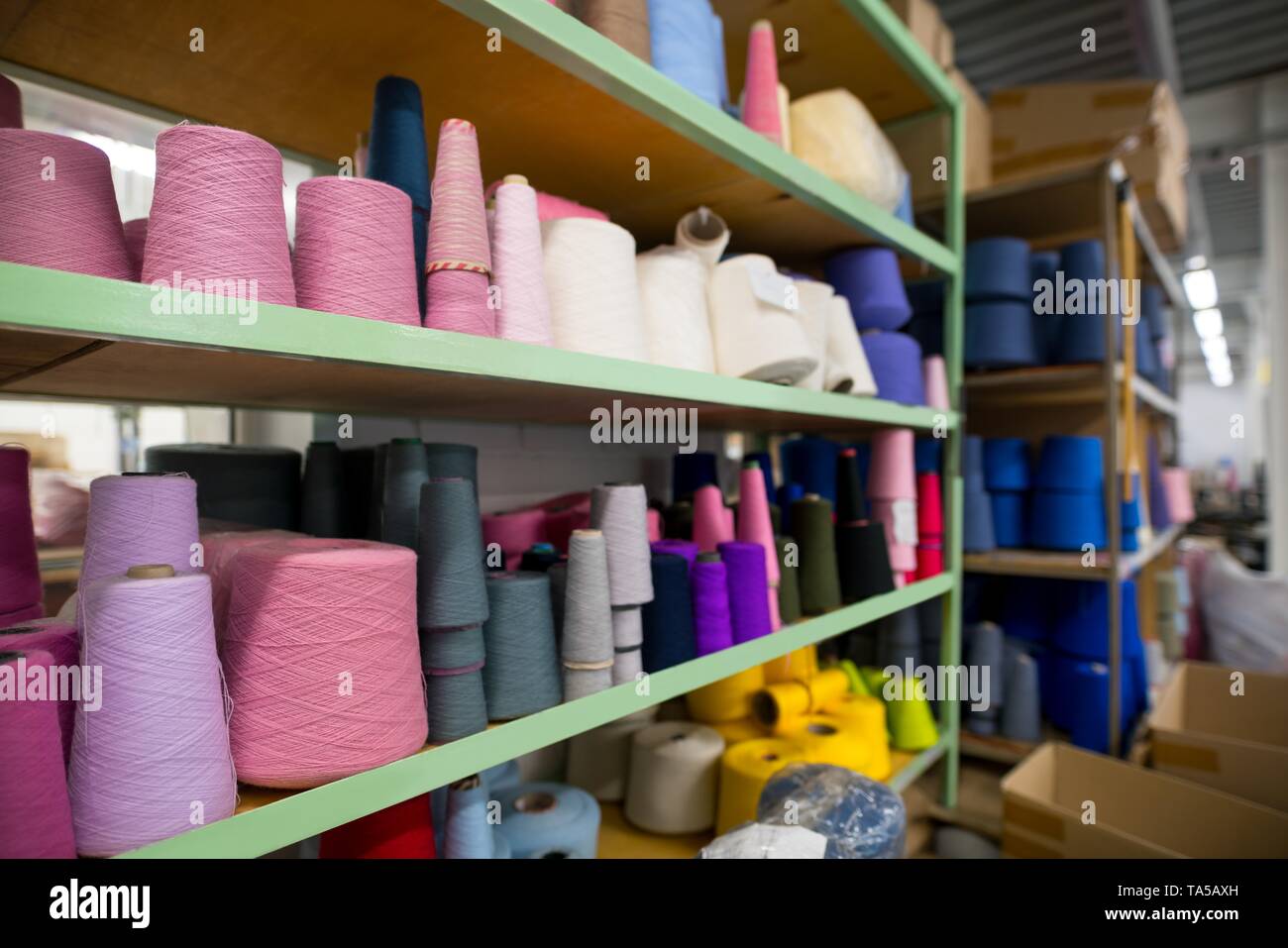 Sewing thread bobbins in manufactoring plant Stock Photo - Alamy