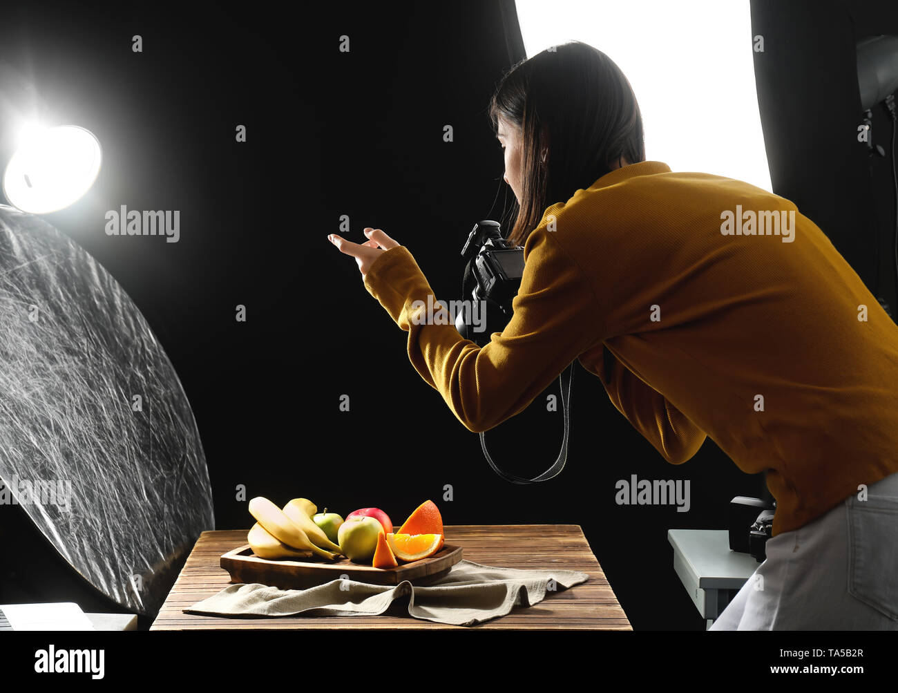 Female photographer working in professional photo studio Stock Photo ...
