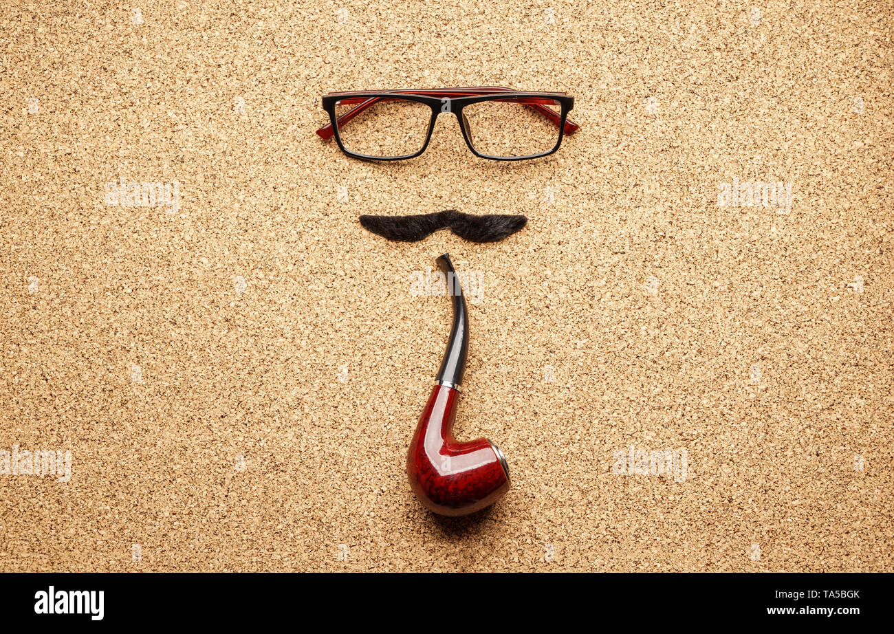 Funny composition with eyeglasses, smoking pipe and moustache on cork ...