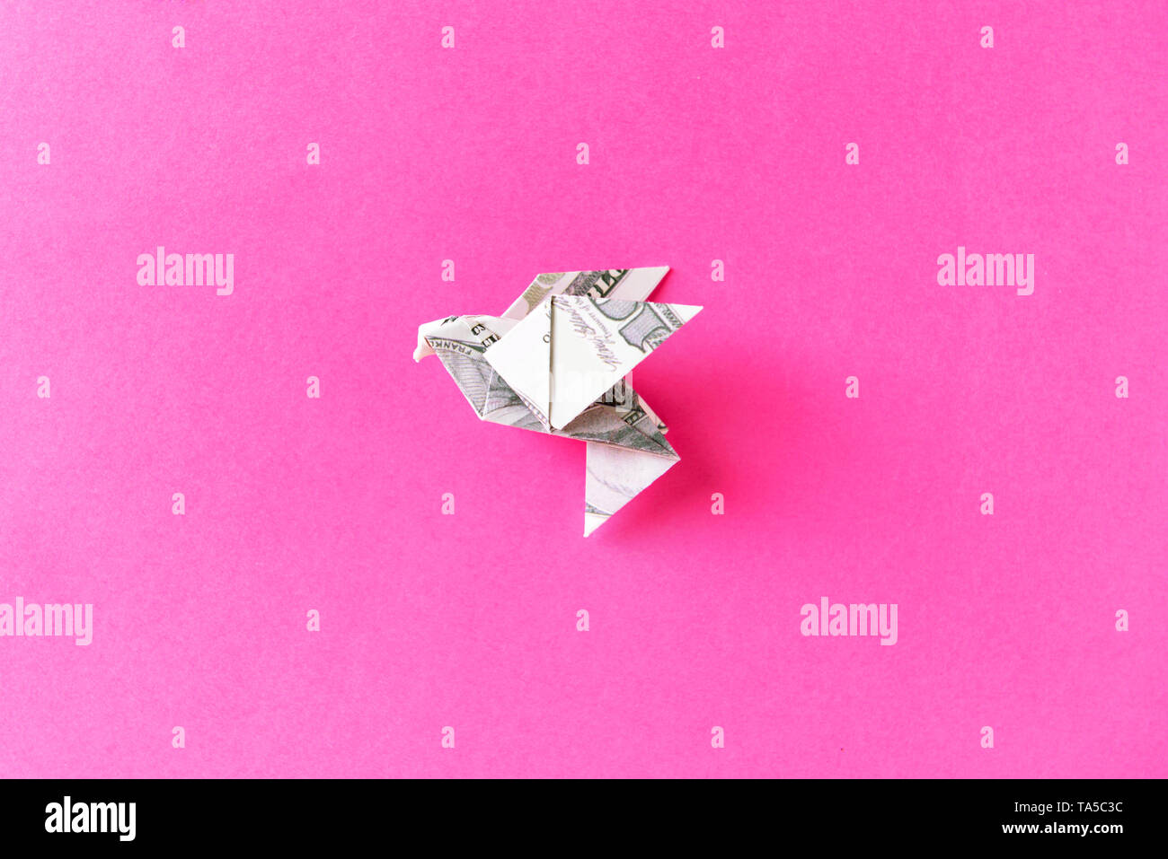 Origami bird made of dollar banknote on color background Stock Photo ...