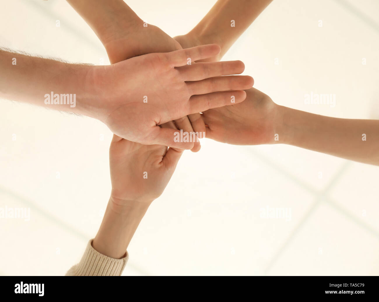 People putting hands together as symbol of unity Stock Photo - Alamy