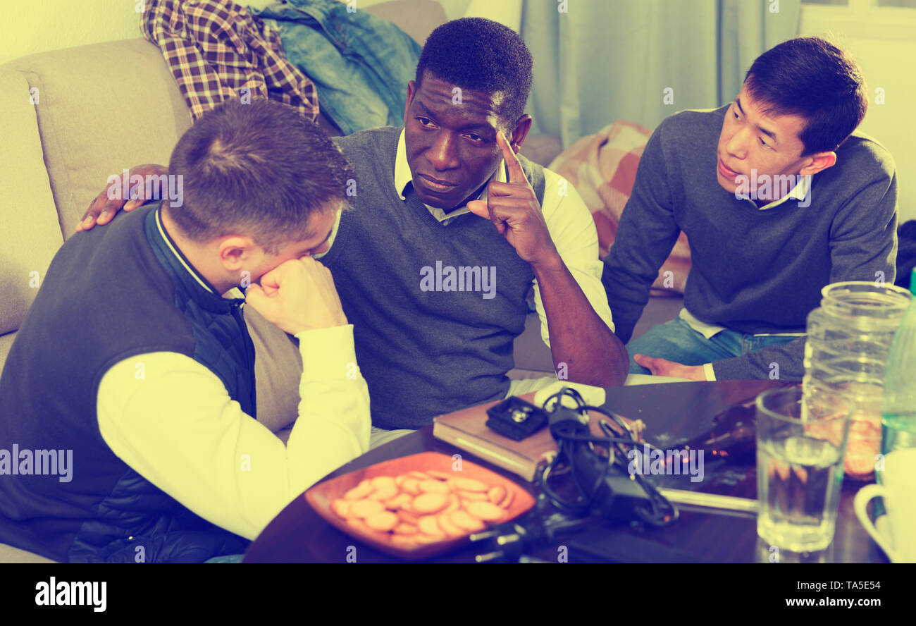 Two friends are talking about life and supporting sad man at home Stock ...