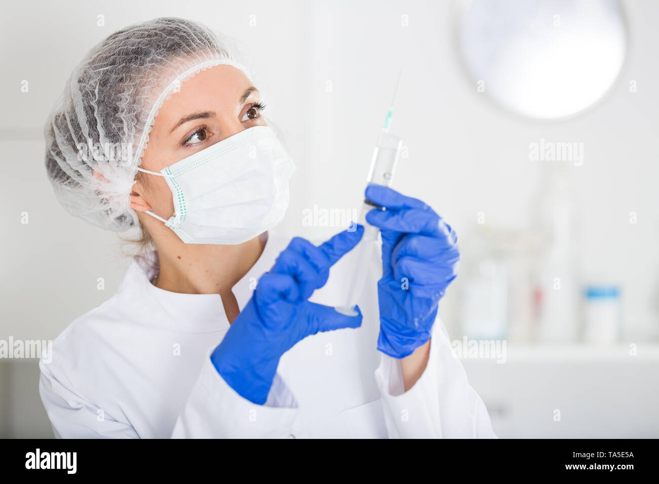 Female nurse holding syringe for injection in hospital Stock Photo - Alamy