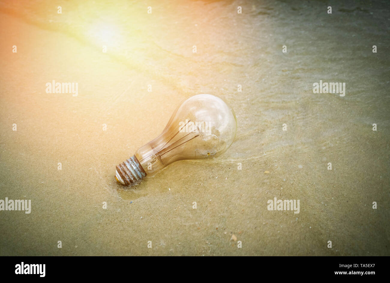 light bulb on beach / old light bulb on sand in the beach - save the ...