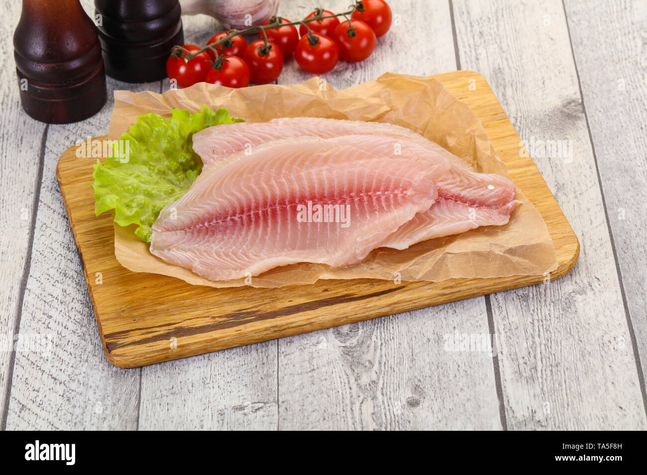 Raw tilapia fish ready for cooking Stock Photo - Alamy