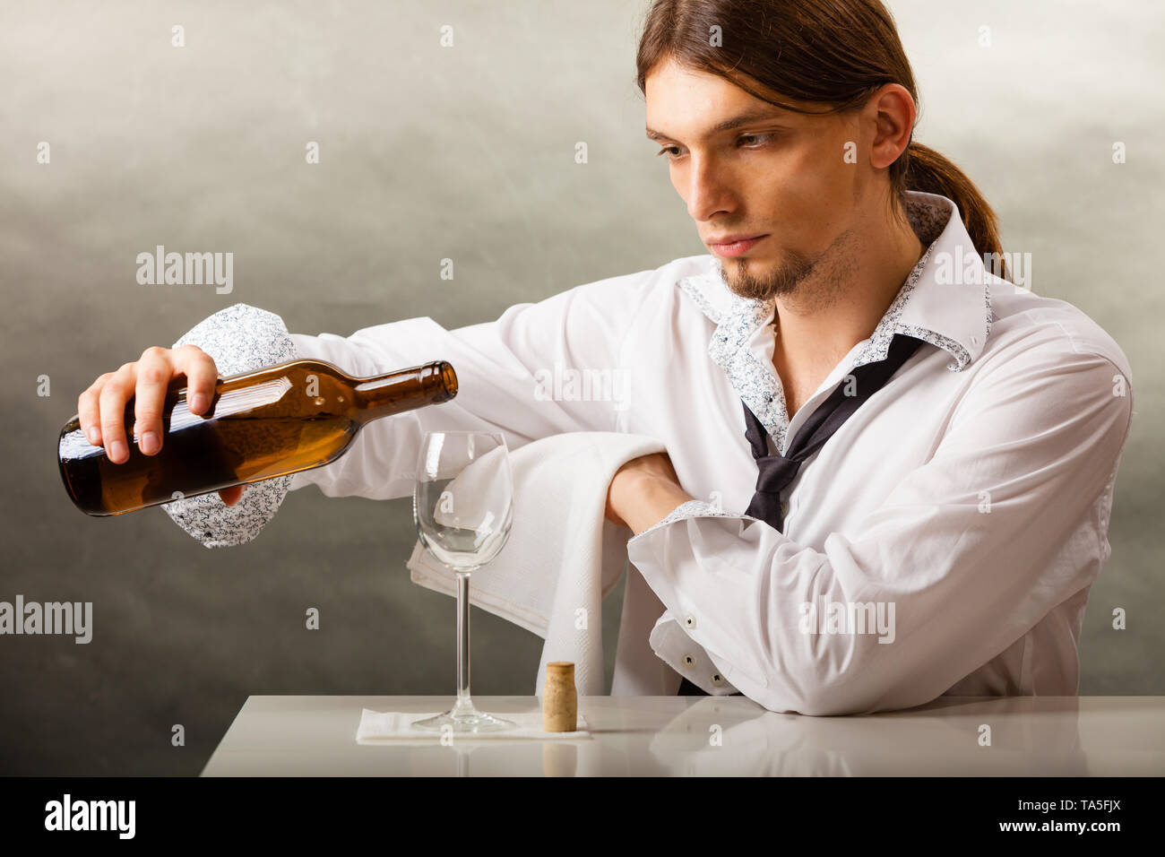Male waiter or butler serving pouring wine into glass Stock Photo - Alamy