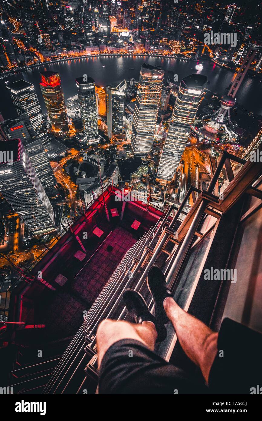 Extreme photography with the photograph standing on one of the tallest ...