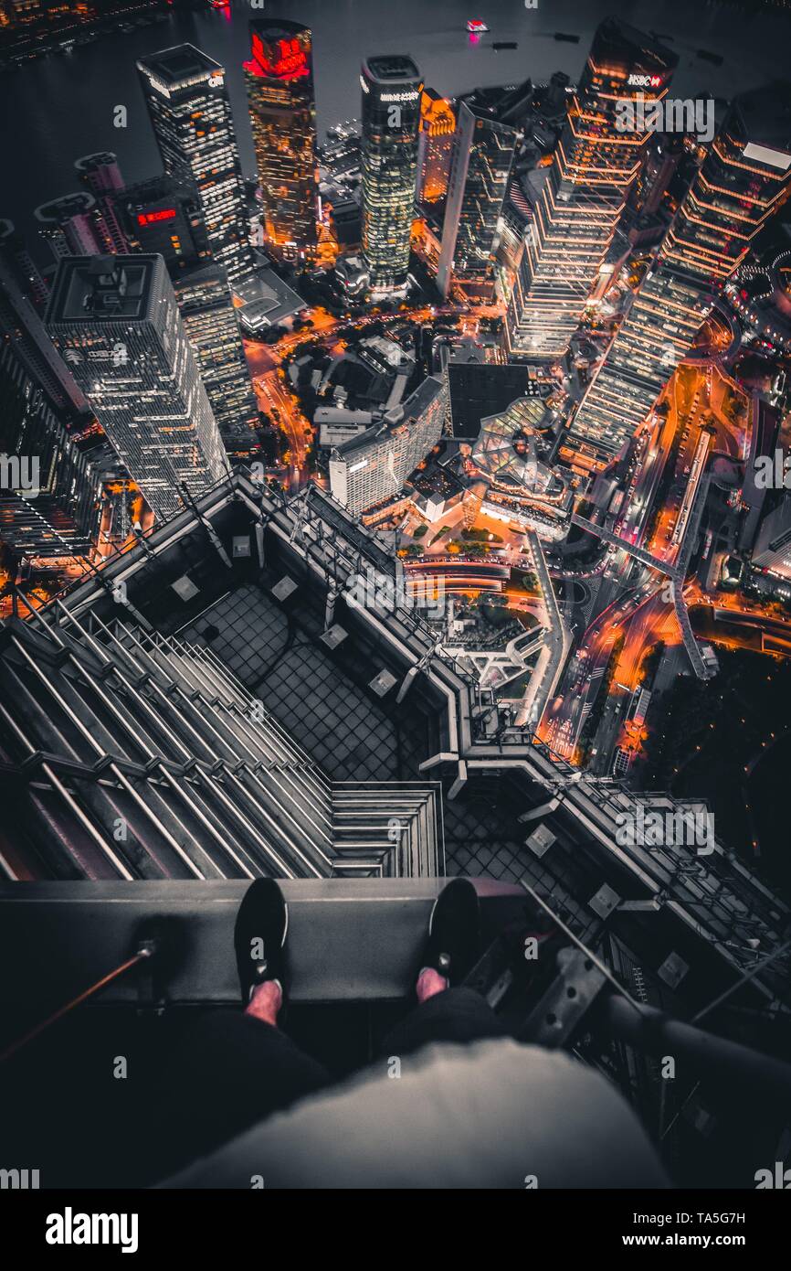 Extreme photography with the photograph standing on one of the tallest ...