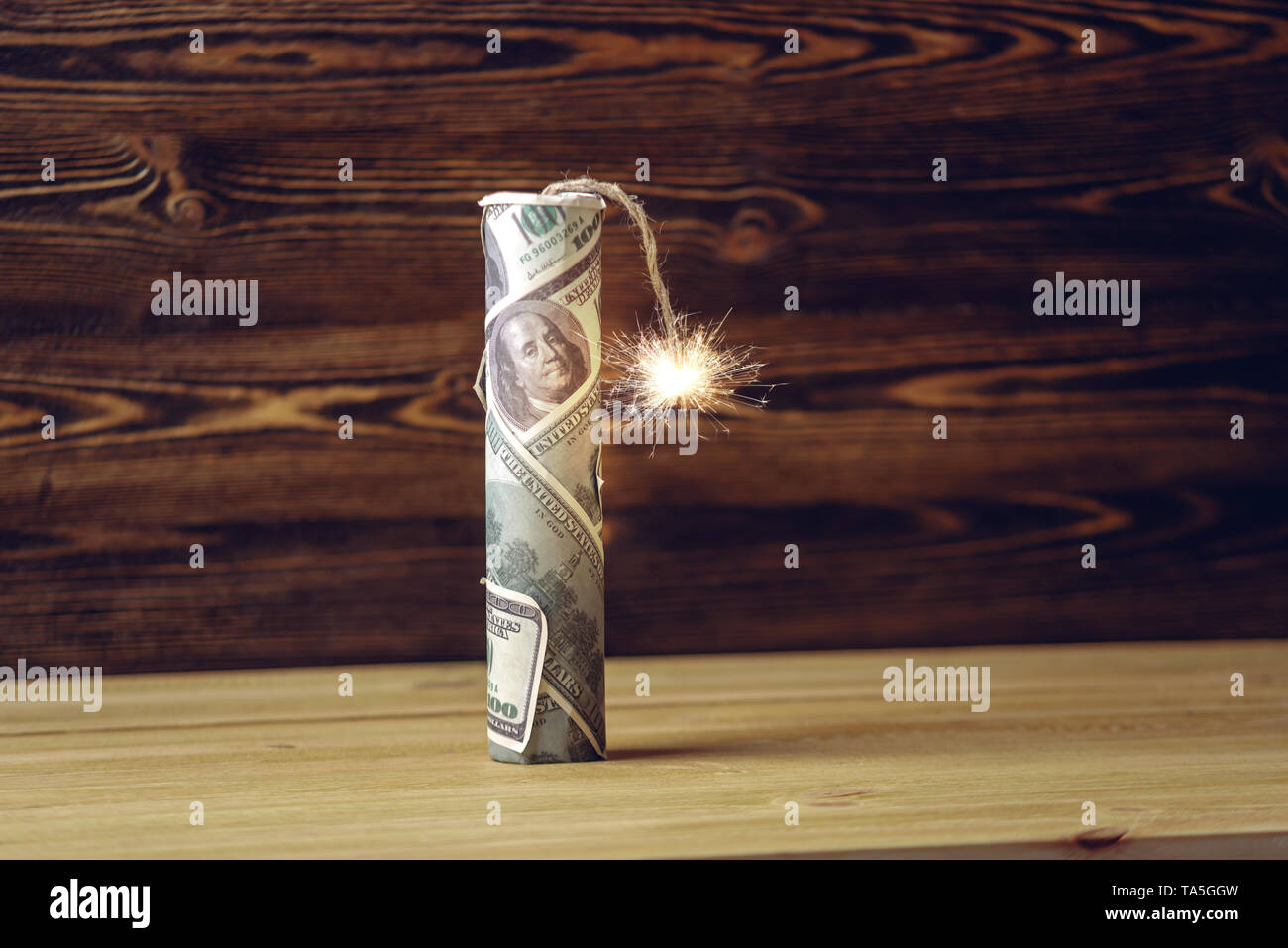 A bomb of money like dynamite, hundred-dollar bills with a burning fuse ...