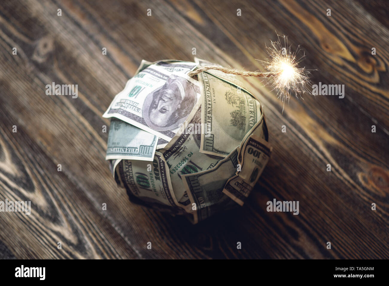 A bomb of money like dynamite, hundred-dollar bills with a burning fuse ...
