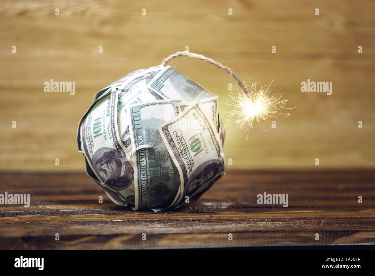 A bomb of money like dynamite, hundred-dollar bills with a burning fuse ...
