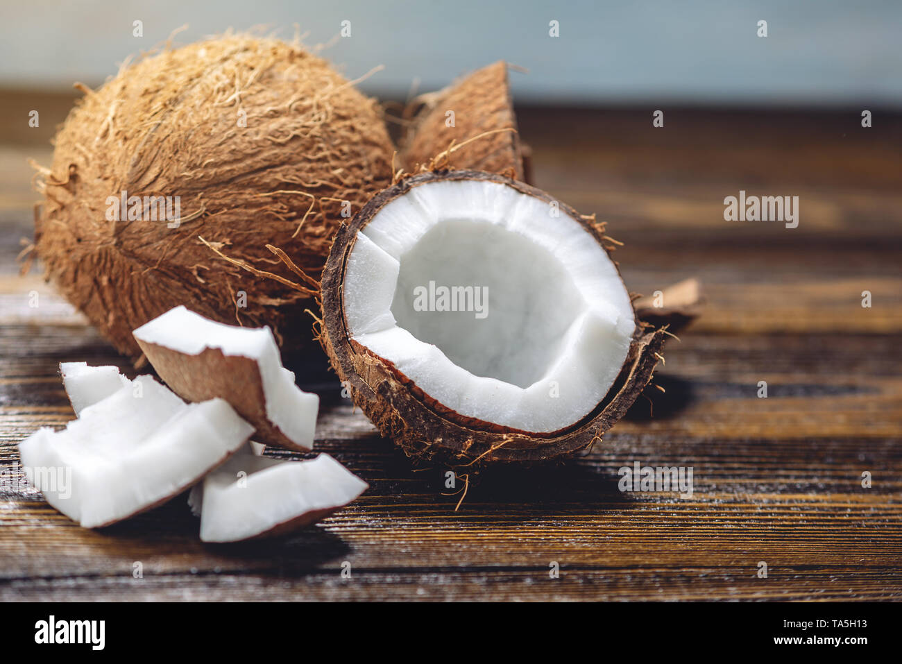 Open coconut with white pulp on wooden background. Organic healthy ...