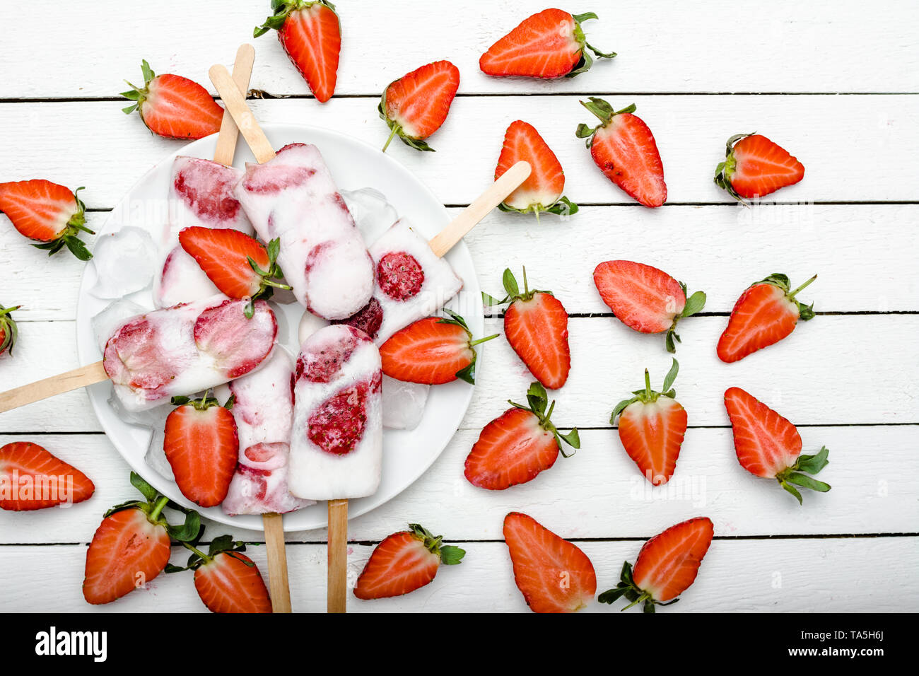 Natural juicy strawberry popsicles. Refreshing ice pops, overhead, flat ...