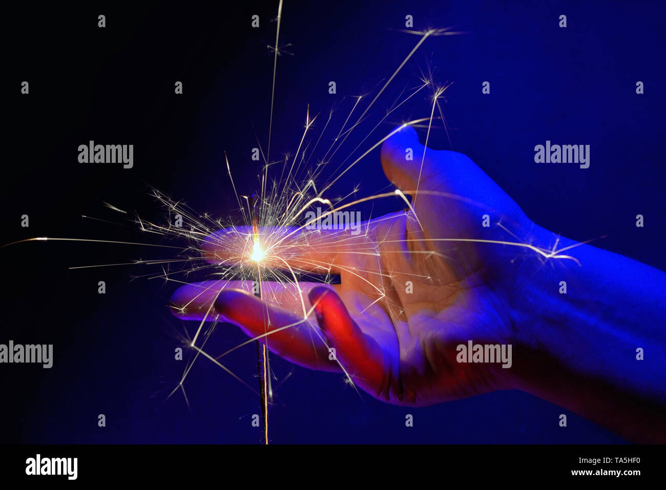 Hand Holding Fire Light Sparkler in night Stock Photo - Alamy
