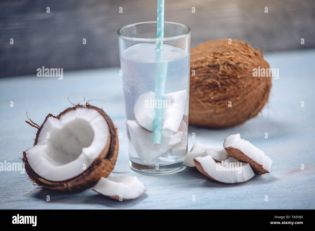 Coconut water in the composition with an open coconut with white flesh ...