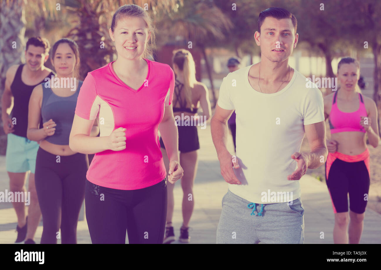 Active smiling people during running training in daytime Stock Photo ...