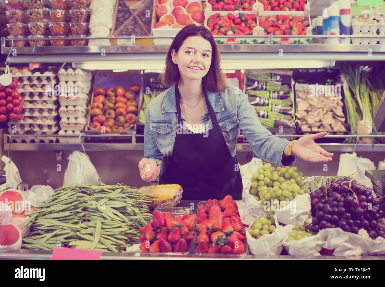 happy english female shopping assistant demonstrating assortment of ...
