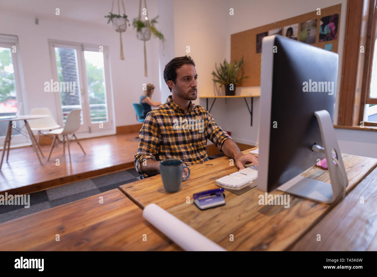 Man executive working on his computer at his desk in the office Stock ...