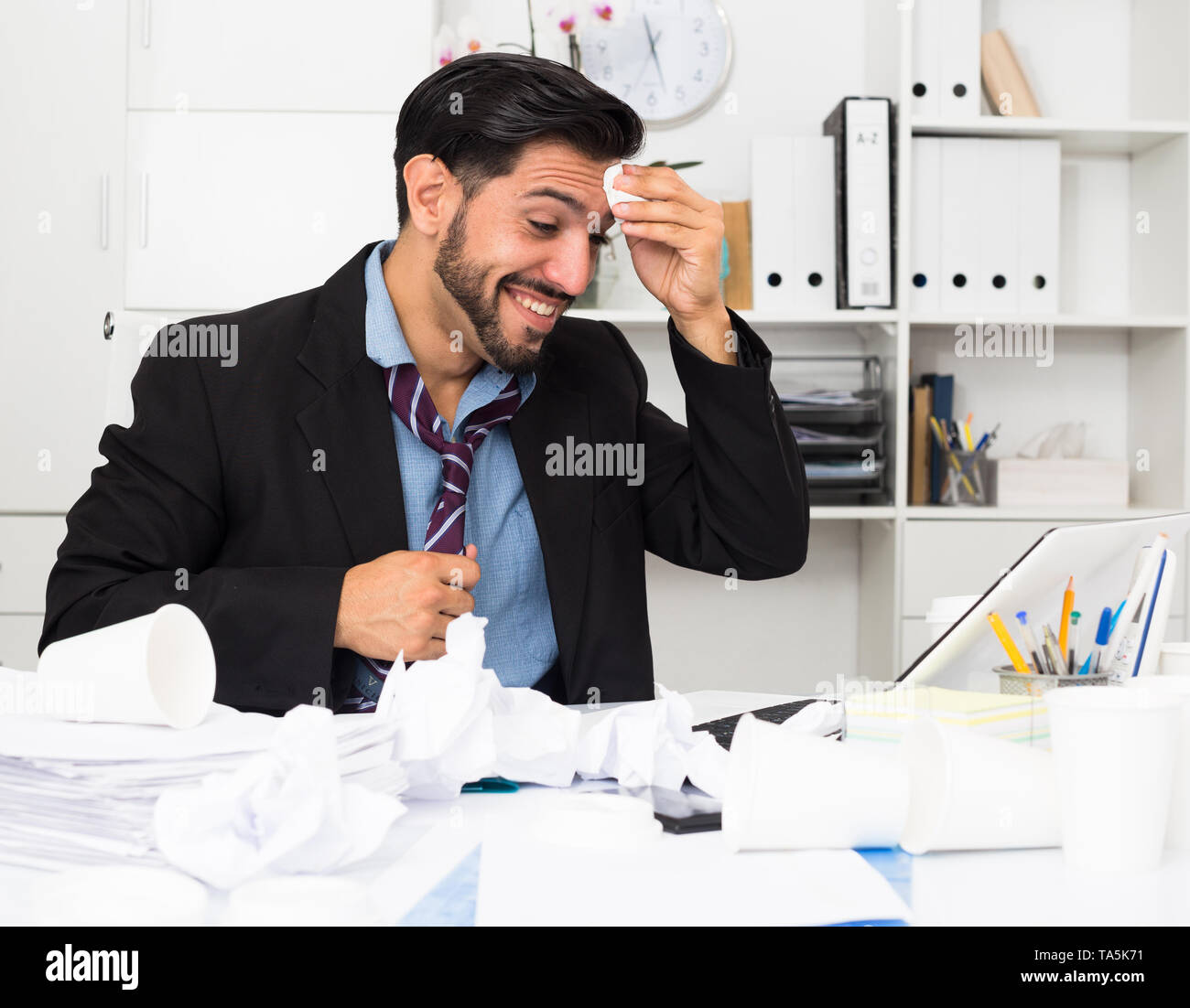 Spanish male worker is having complicated issue with project in office ...